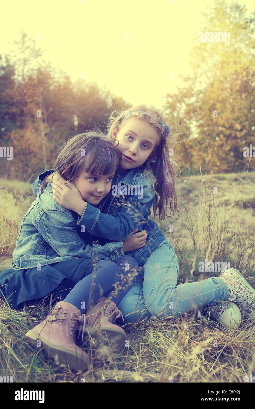 Two sisters hug Stock Photo - Alamy