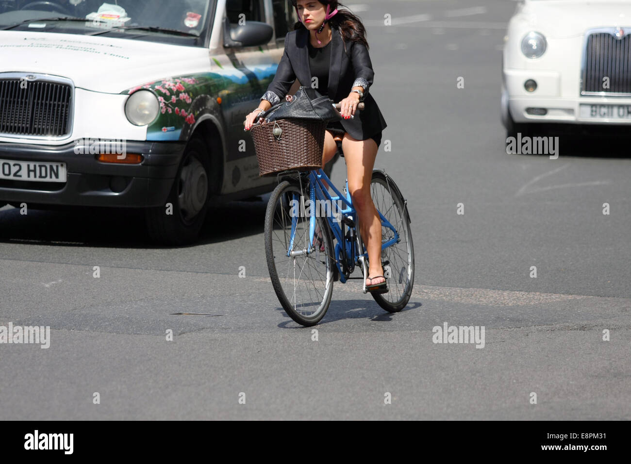 A female cyclist riding in London traffic Stock Photo - Alamy