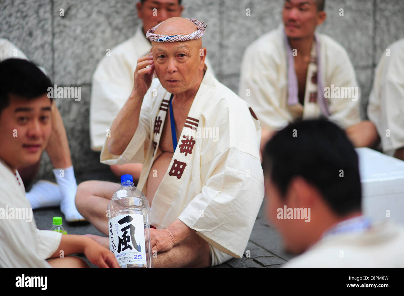Omikoshi (portable shrine) carriers take a break in between sessions ...