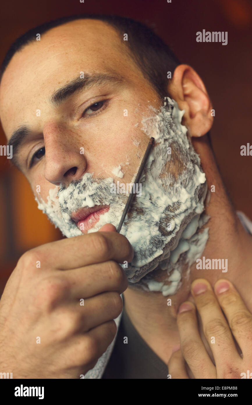 Young man getting old fashioned shave hi-res stock photography and ...