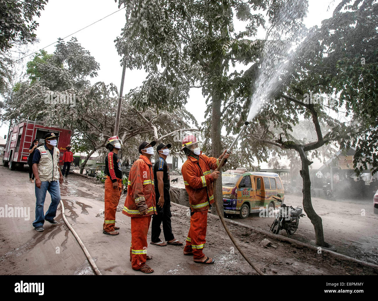 North Sumatra, Indonesia. 13th Oct, 2014. Firefighters clean the ash ...
