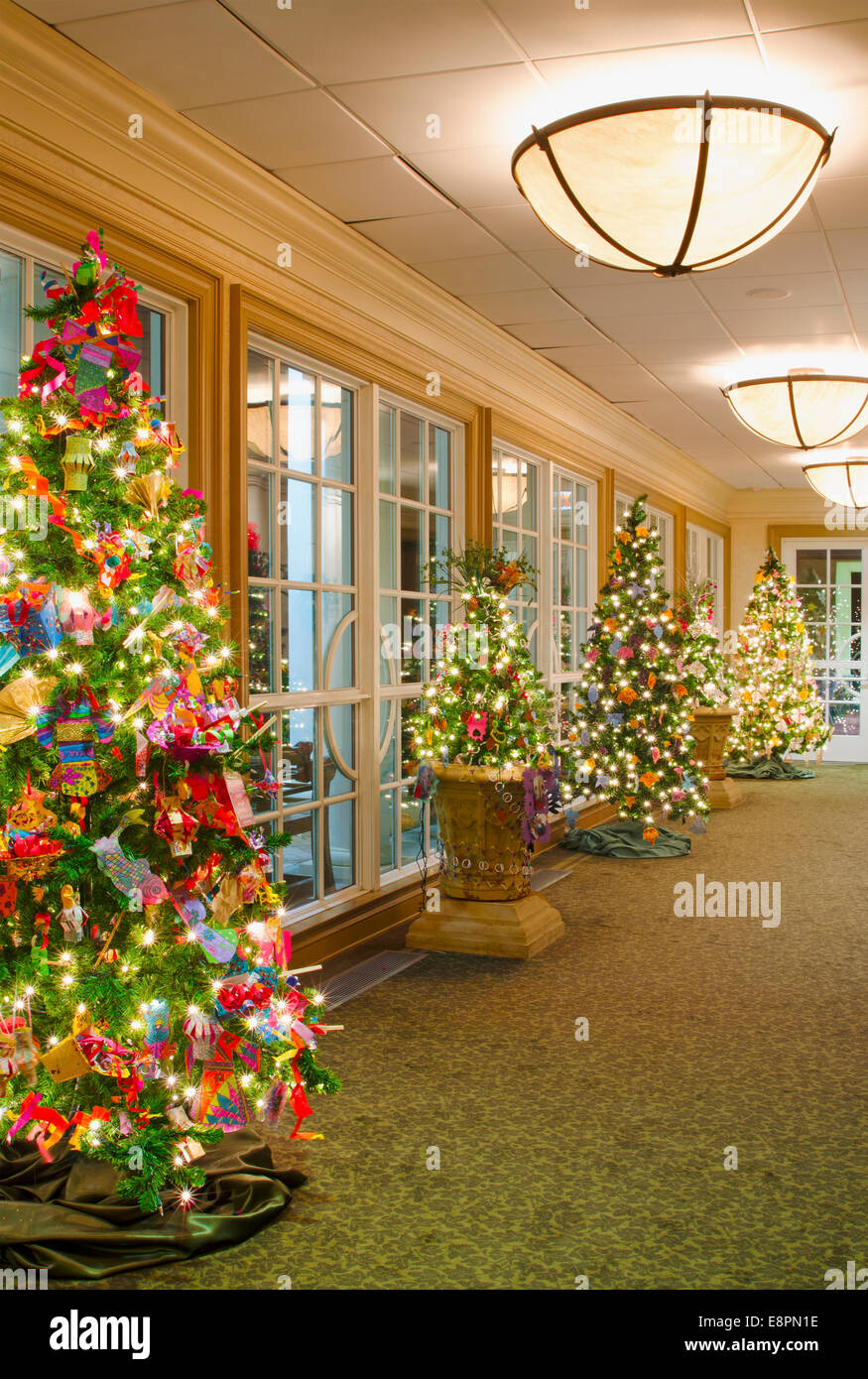 A row of Christmas Trees decorated with hand-crafted ornaments line ...
