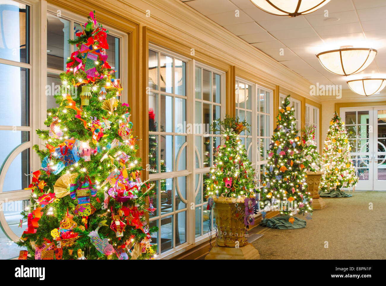 A row of Christmas Trees decorated with hand-crafted ornaments line ...