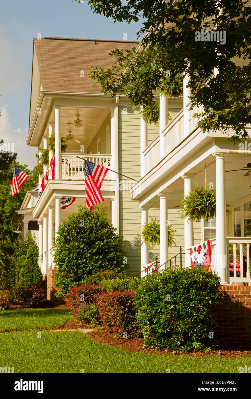 An American Flag and buntings hang from a front porch of these ...
