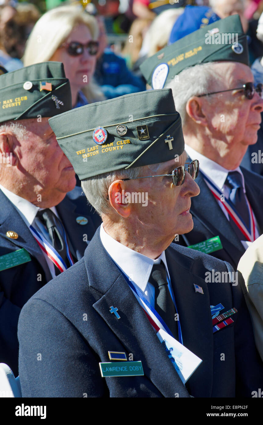 World War II Veterans give their attention during a speech dedicating a ...