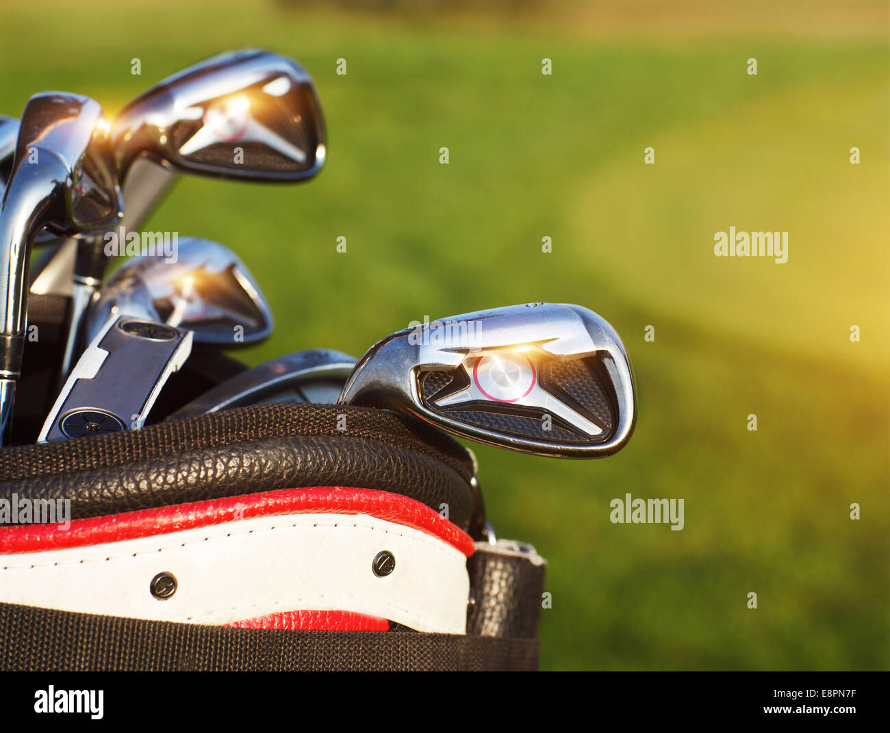 Golf clubs drivers over green field background. Summer sunset Stock ...