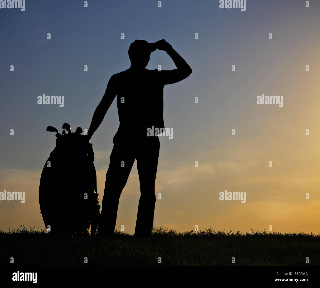 Male golfer playing golf at sunset Stock Photo - Alamy