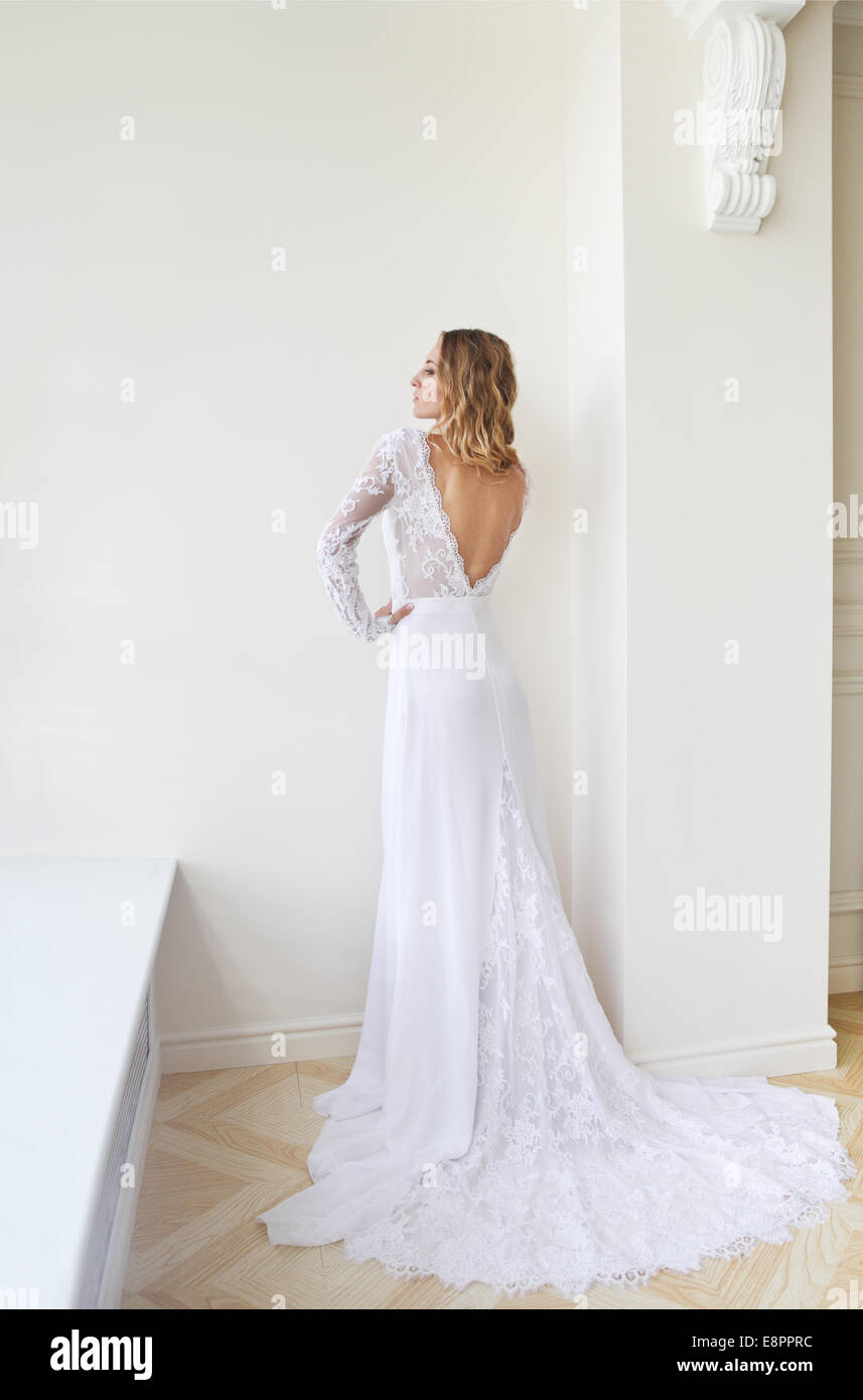 The beautiful bride in an interior in light tones Stock Photo - Alamy