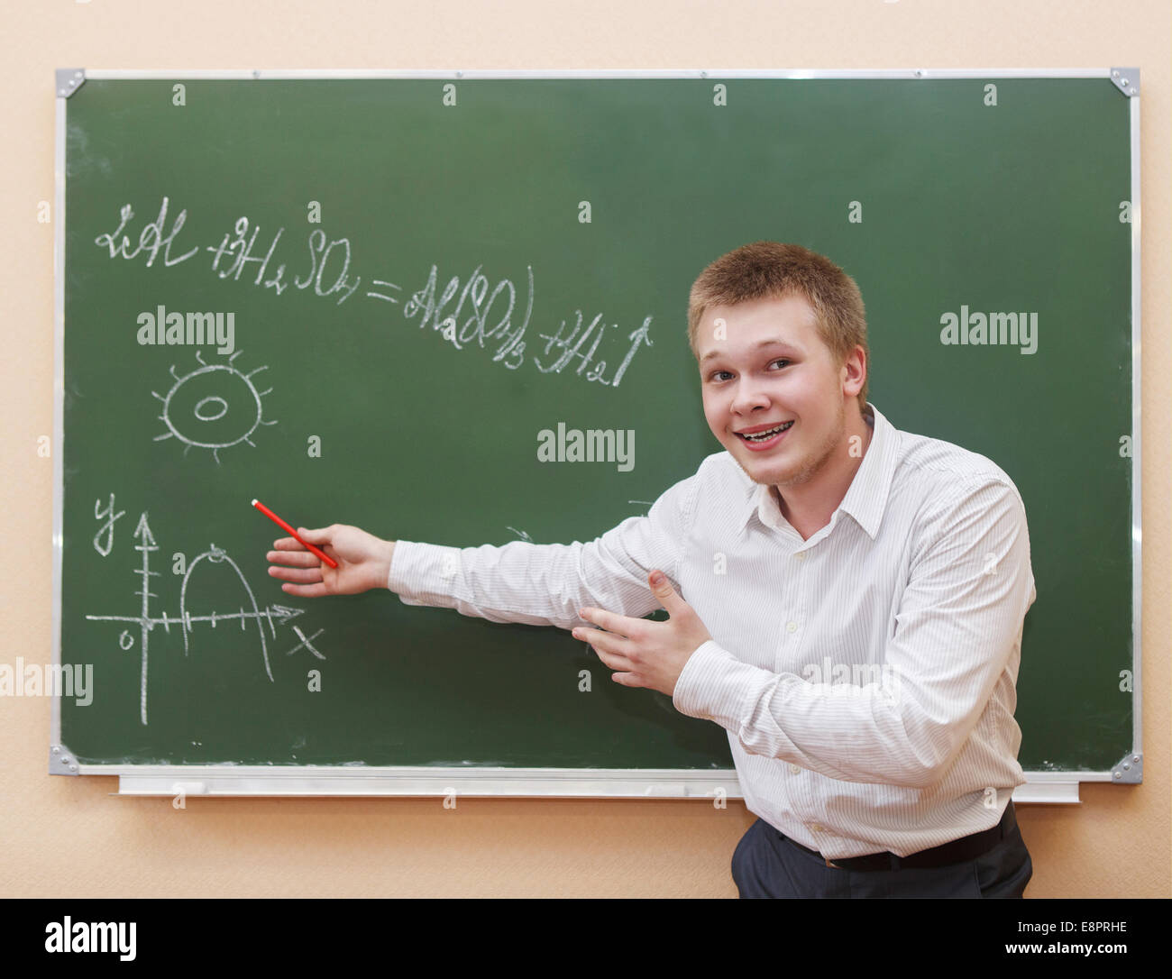Student boy standing near the blackboard in the classroom Stock Photo ...