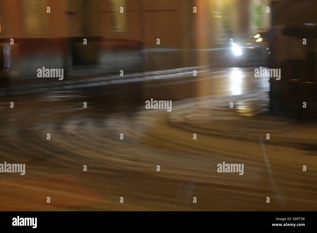 Car driving on an icy road reflected in a shop window. Swedish city on ...