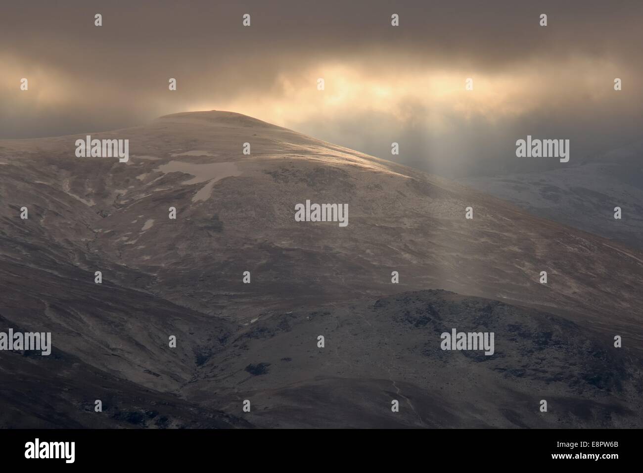 A shaft of sunlight bursts through clouds with the Dodd aHelvellyn ...
