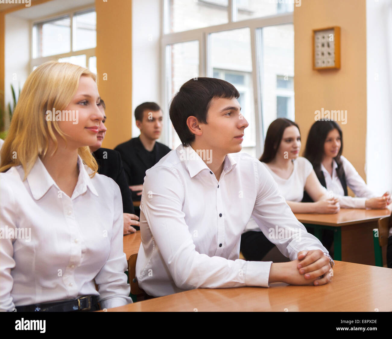 Students in class room listening to the teacher Stock Photo - Alamy