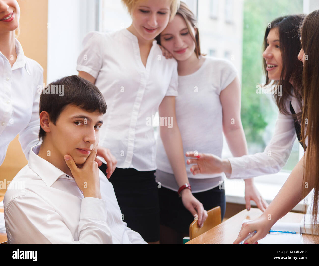 Portrait of young boy in the classroom with friends in background Stock ...