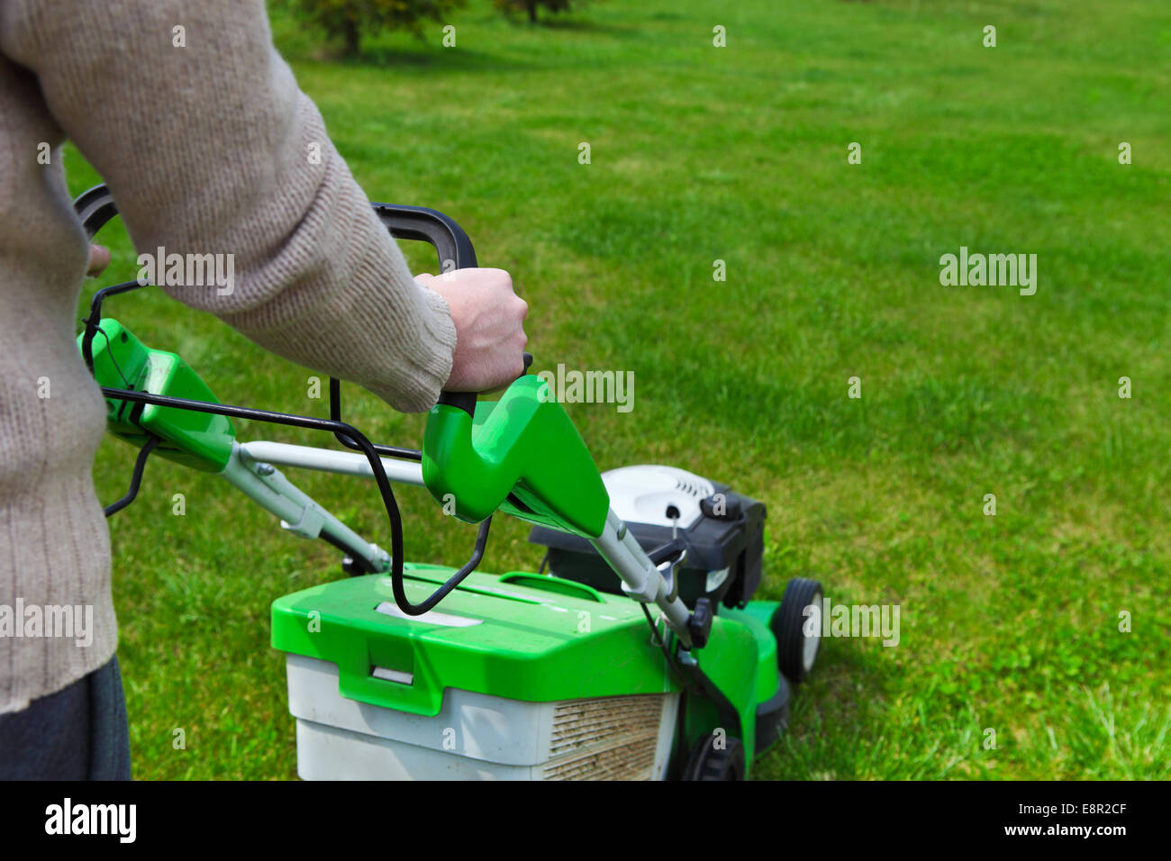 Male gardener mowing the lawn. Gathering Stock Photo - Alamy