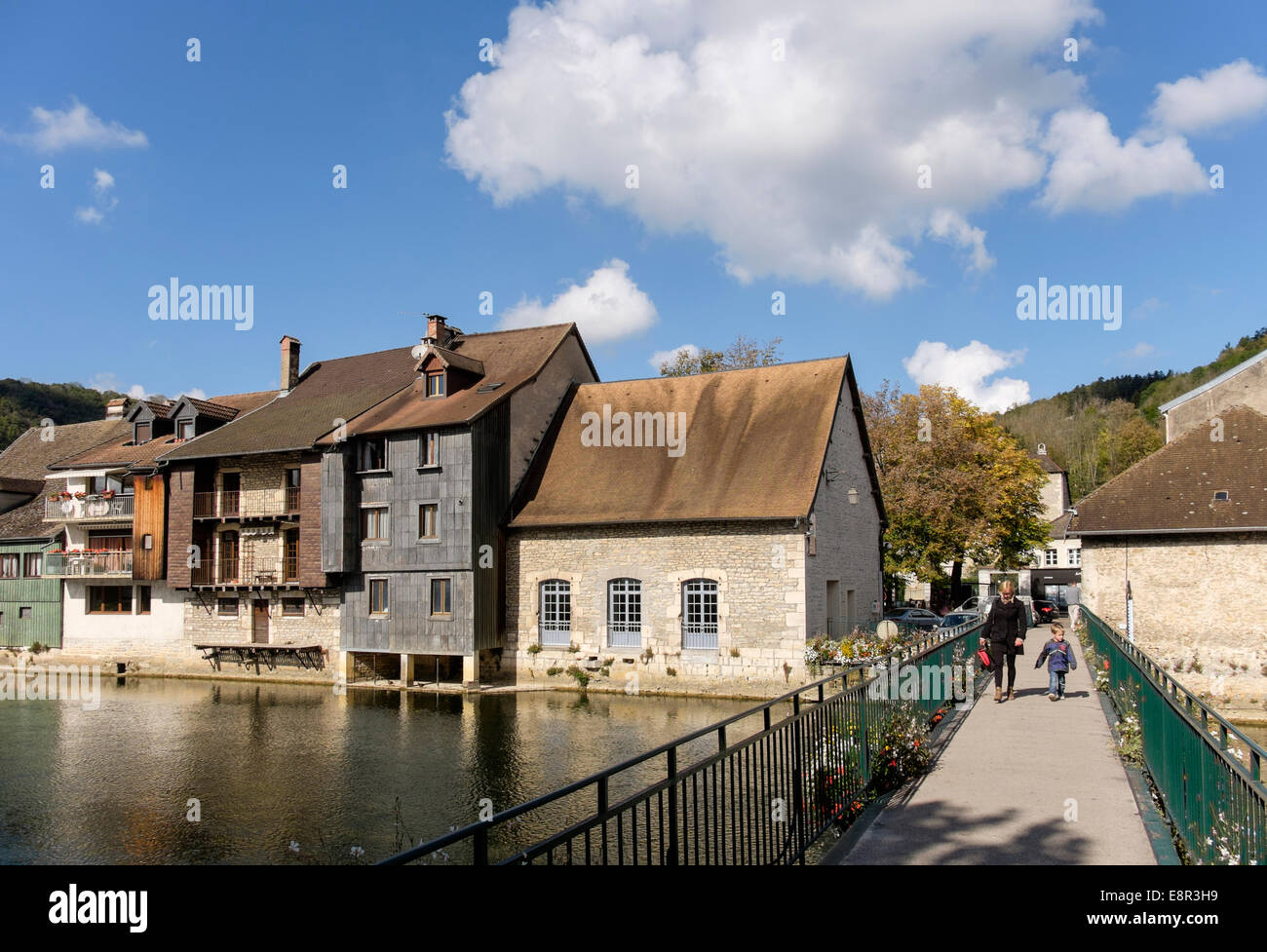 River Loue footbridge with quaint old houses in Loue Valley town of ...