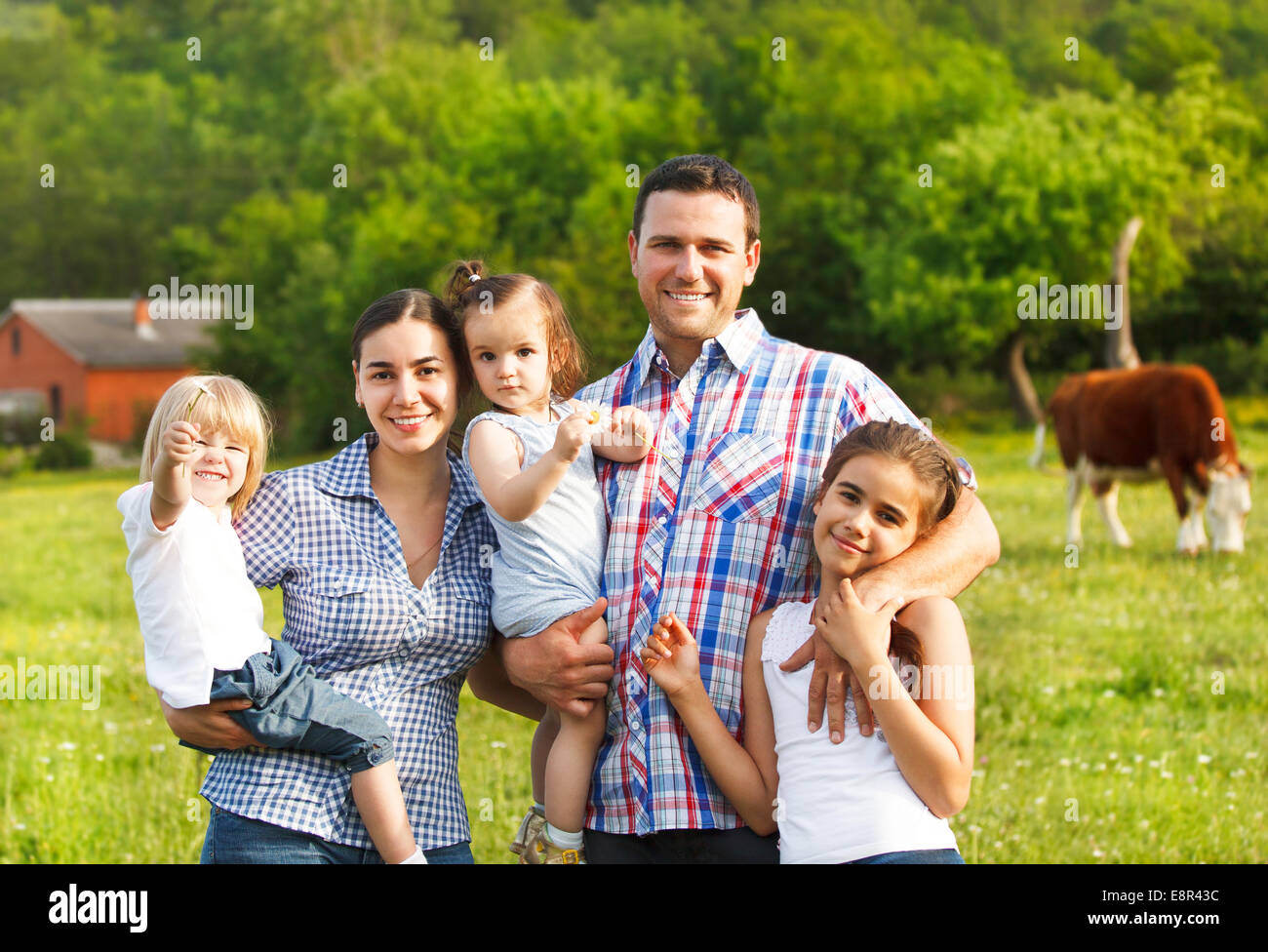 Happy young family with three children on the farm Stock Photo - Alamy