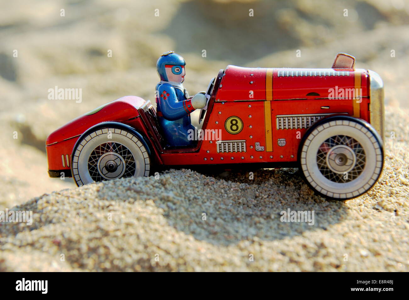 A retro toy race driver sitting in a toy red race car Stock Photo - Alamy