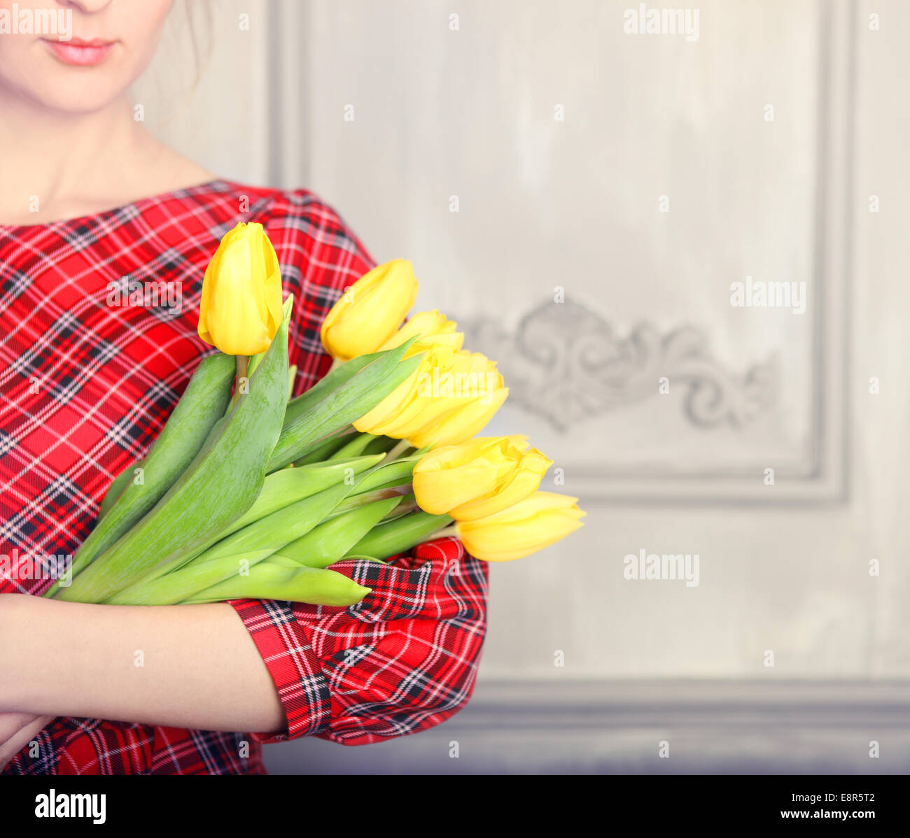 Close up of beautiful romantic woman with blond hair with tulip bouquet ...