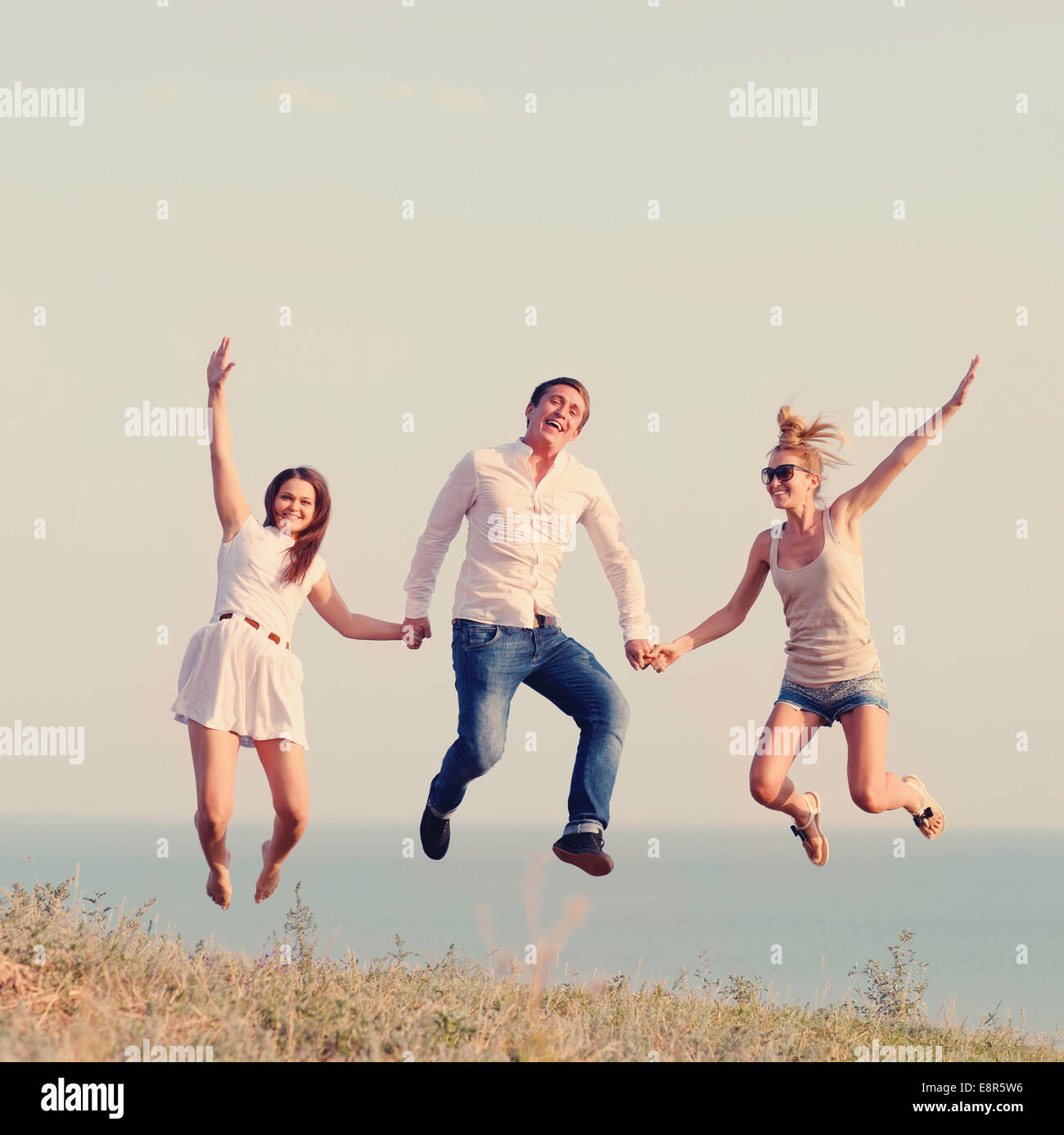 Happy friends jumping on the beach. Summer Stock Photo - Alamy