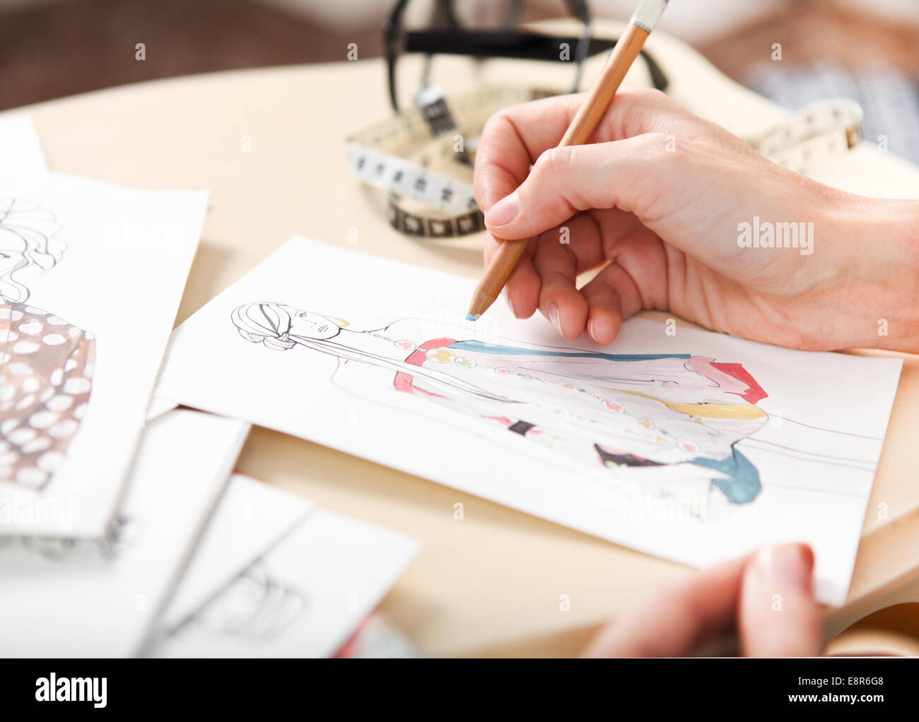 Dressmaker is drawing a fashion sketch. Close up of the hands Stock ...