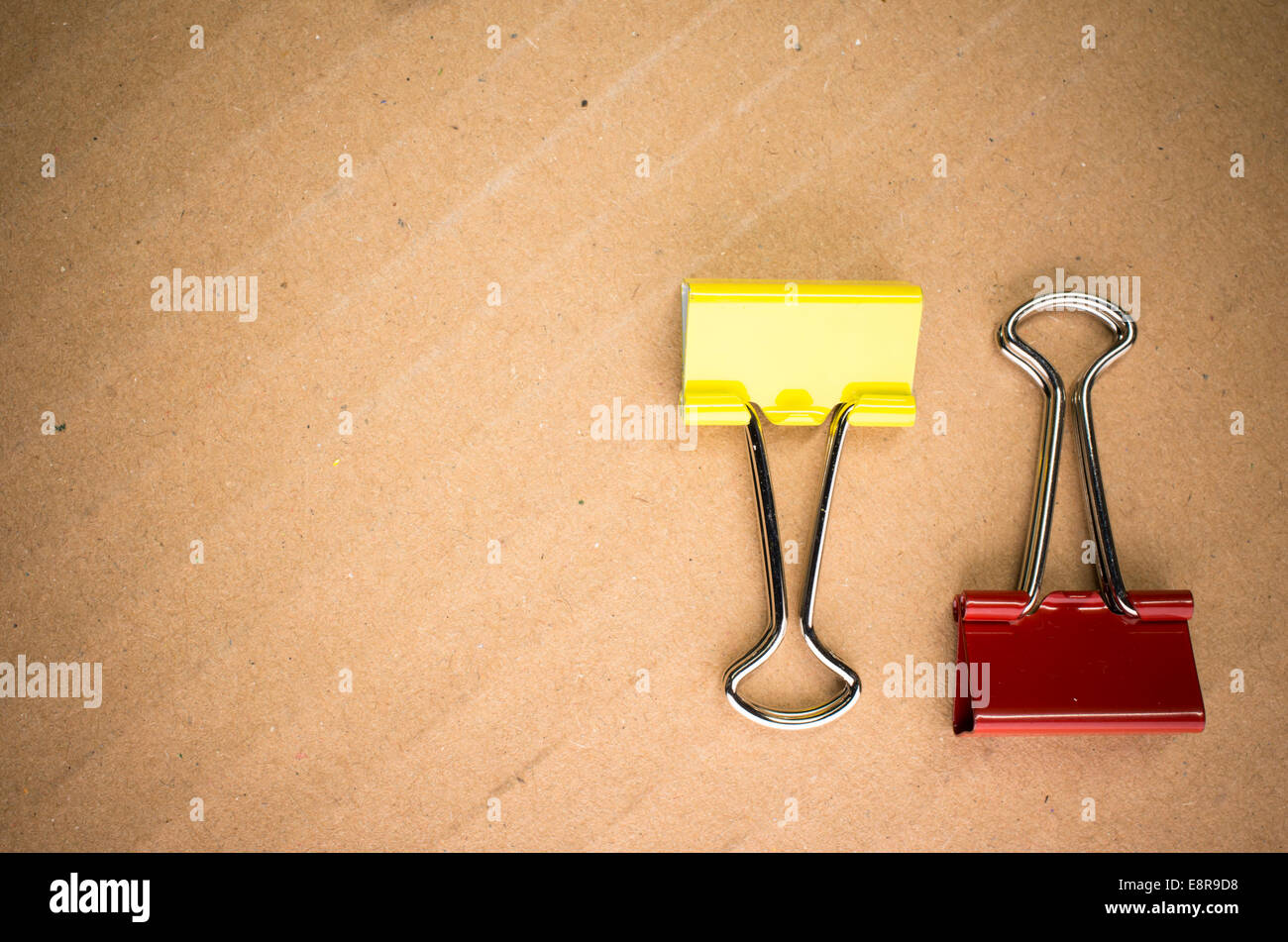 colored metal paper clips on a cardboard background Stock Photo - Alamy