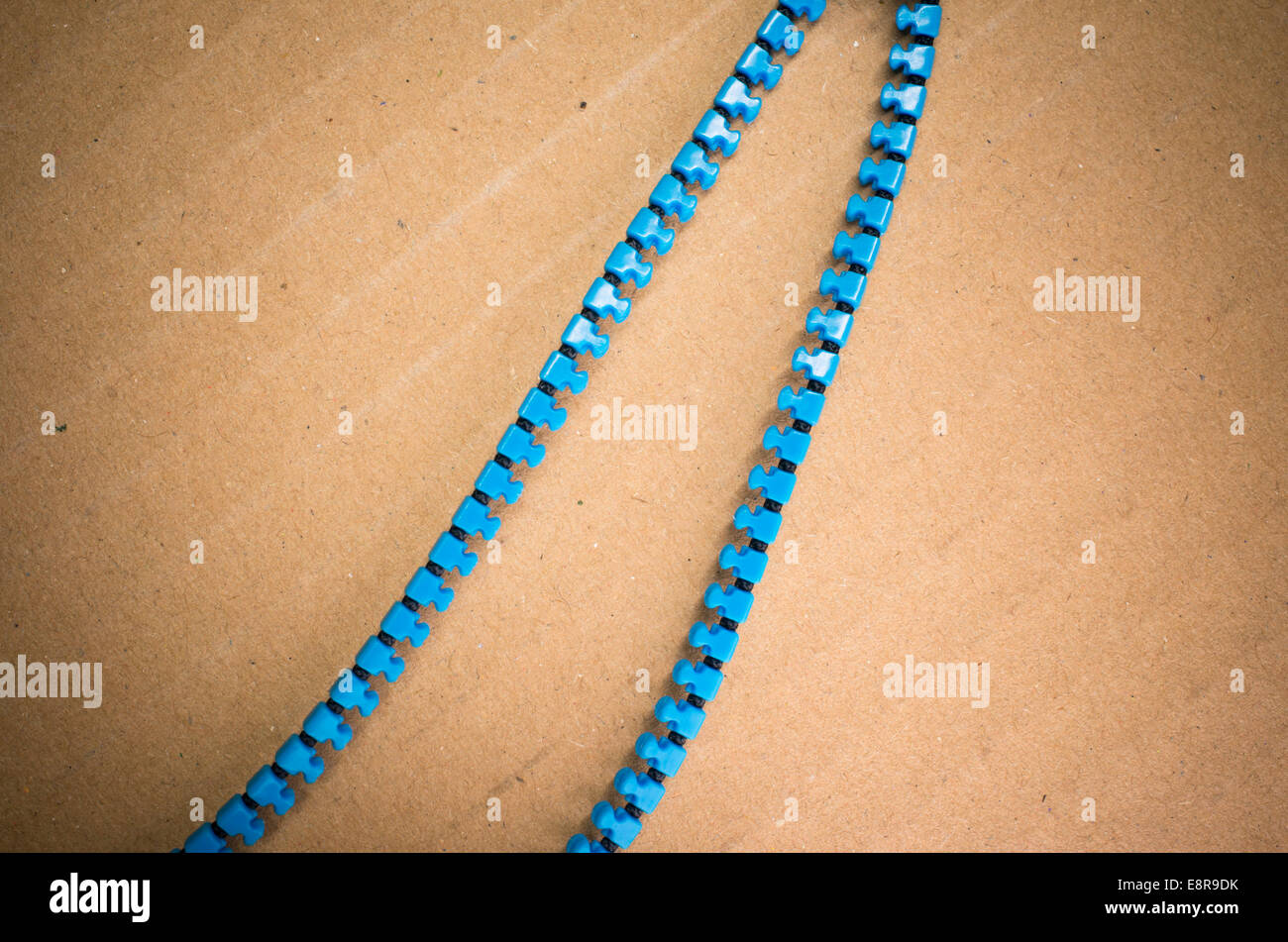 blue zip on a cardboard background Stock Photo - Alamy