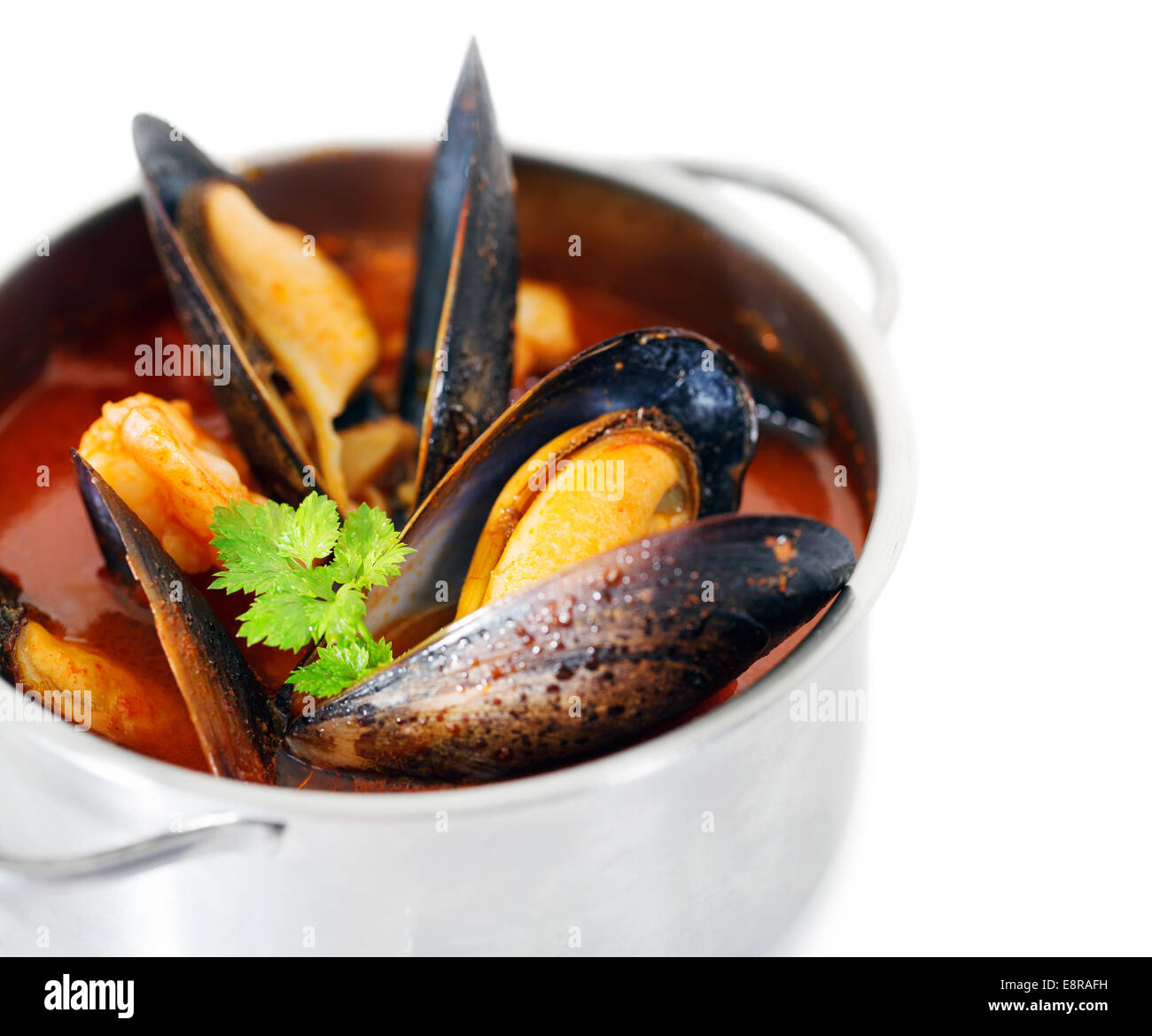 Copper pot of gourmet mussels isolated on white garnished with fresh ...