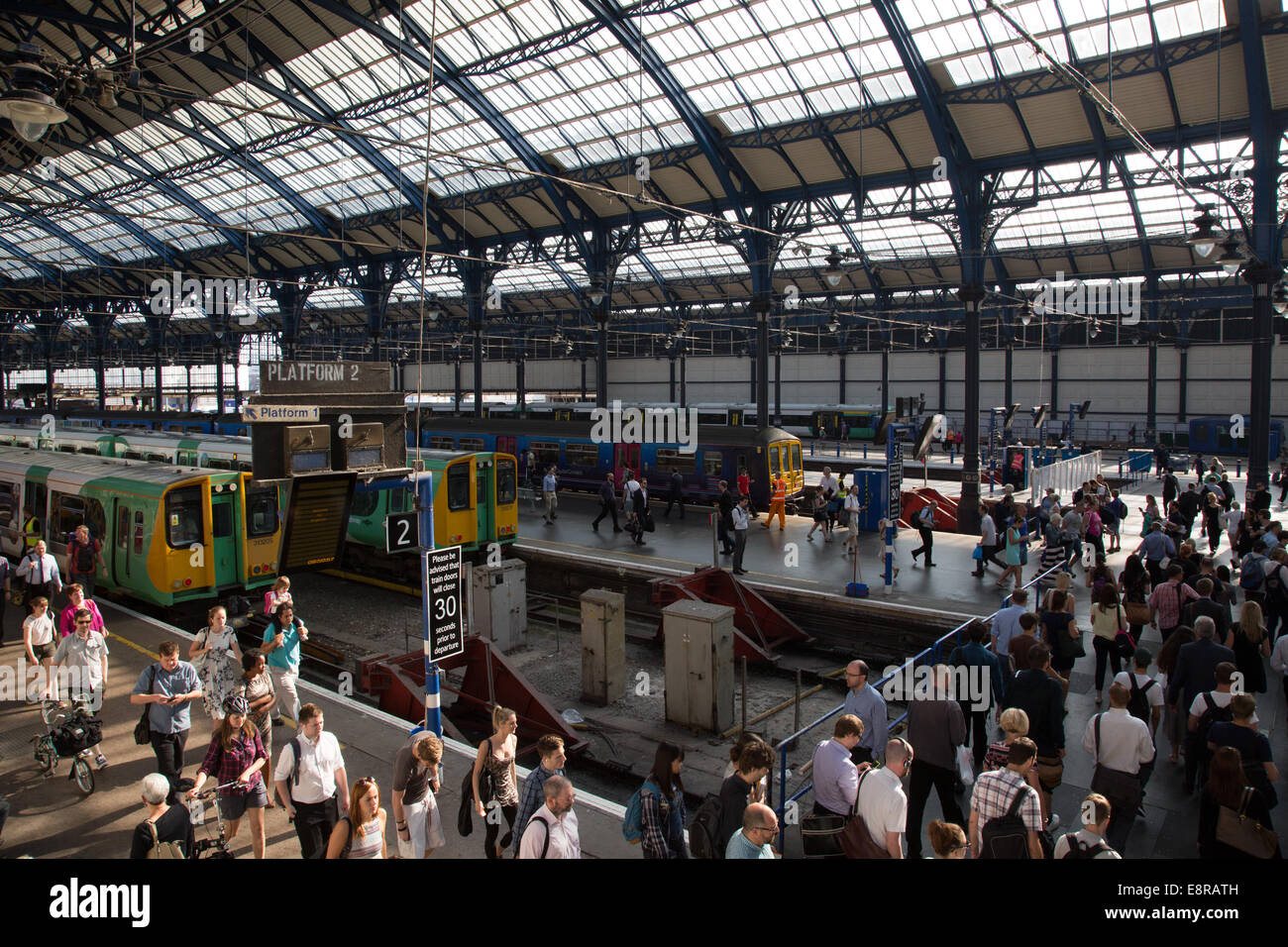 Passengers getting off trains and walking towards ticket gates at ...