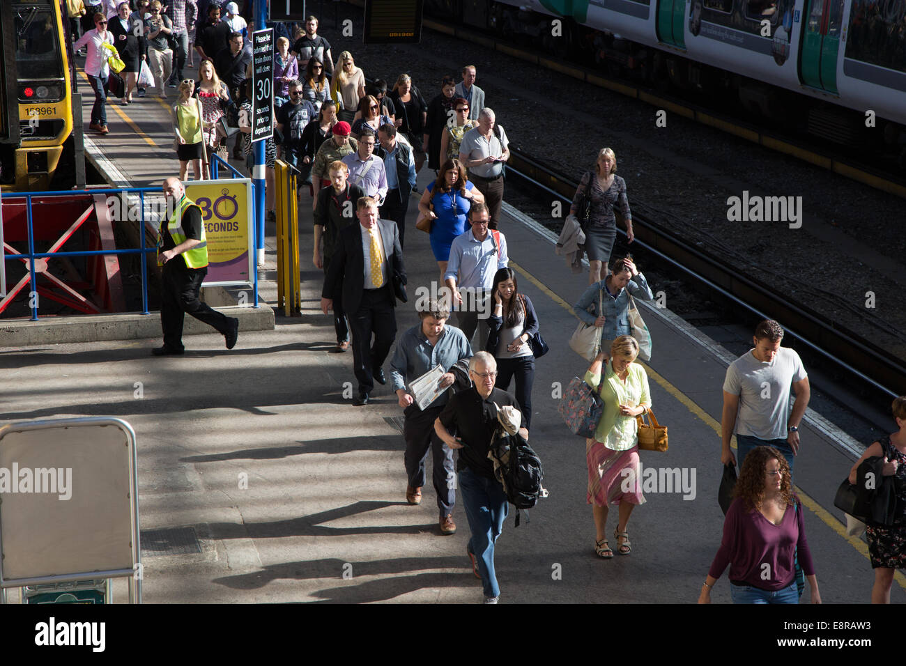Passengers getting off trains and walking towards ticket gates at ...