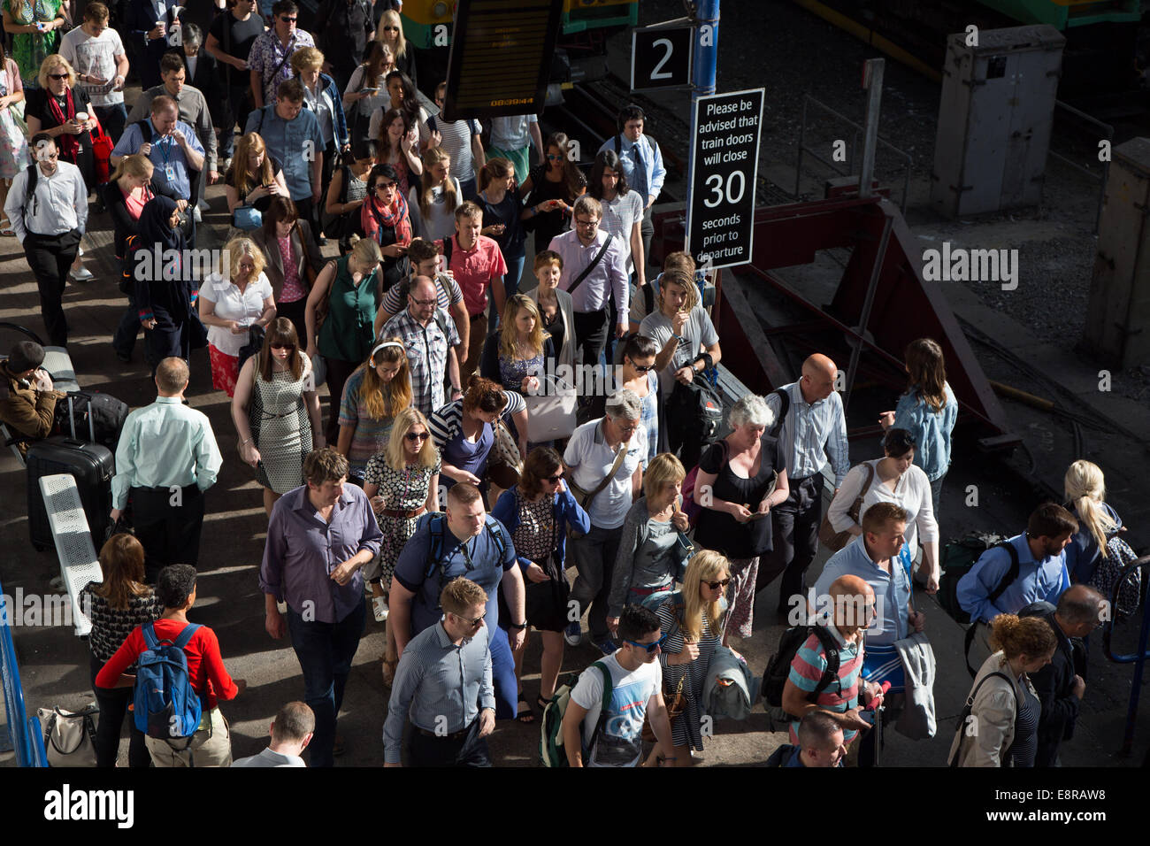 Passengers getting off trains and walking towards ticket gates at ...