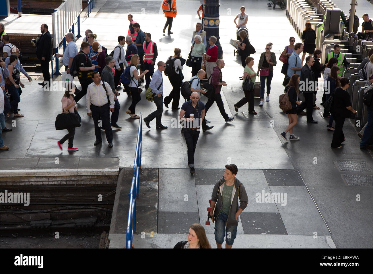 Passengers getting off trains and walking towards ticket gates at ...