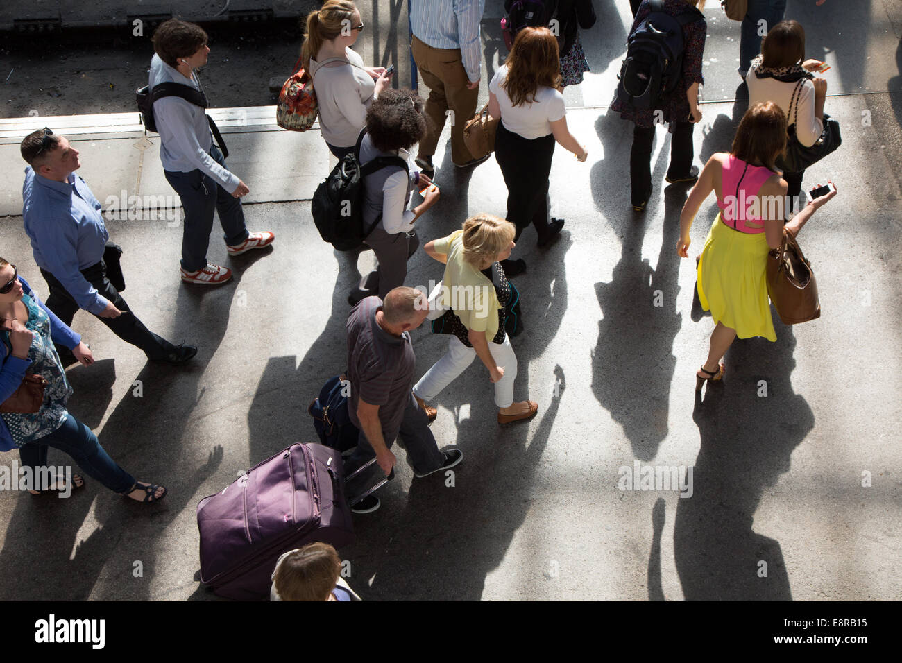 Passengers getting off trains and walking towards ticket gates at ...