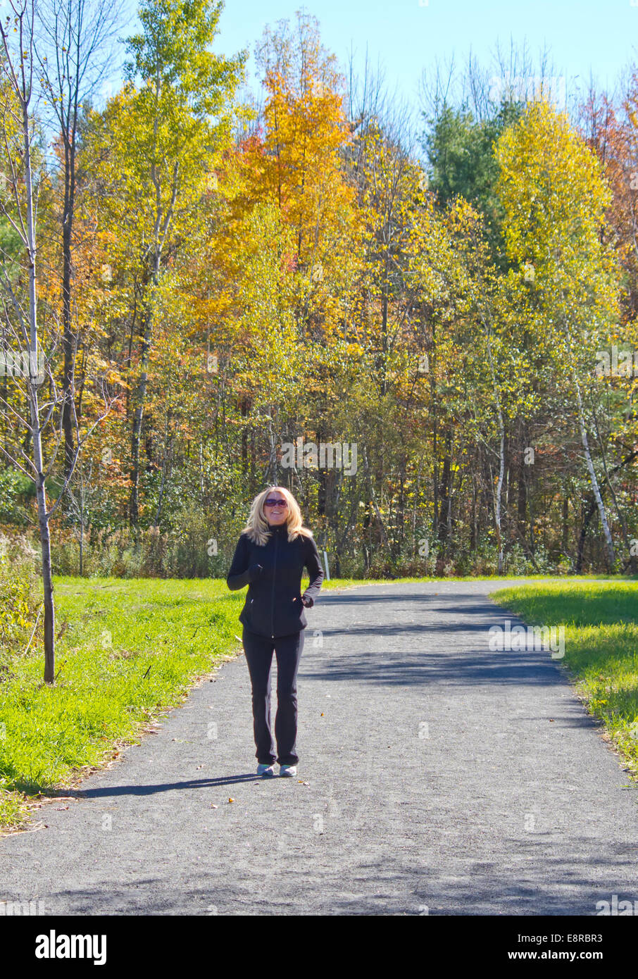 Woman jogging in a park on a fall day Stock Photo - Alamy