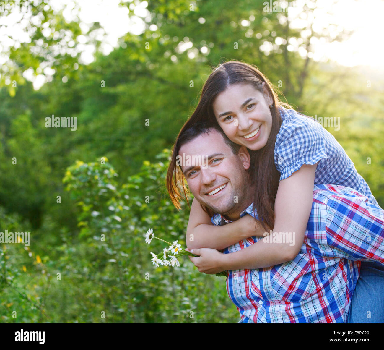 Happy smiling couple in the spring forest. Sunset Stock Photo - Alamy