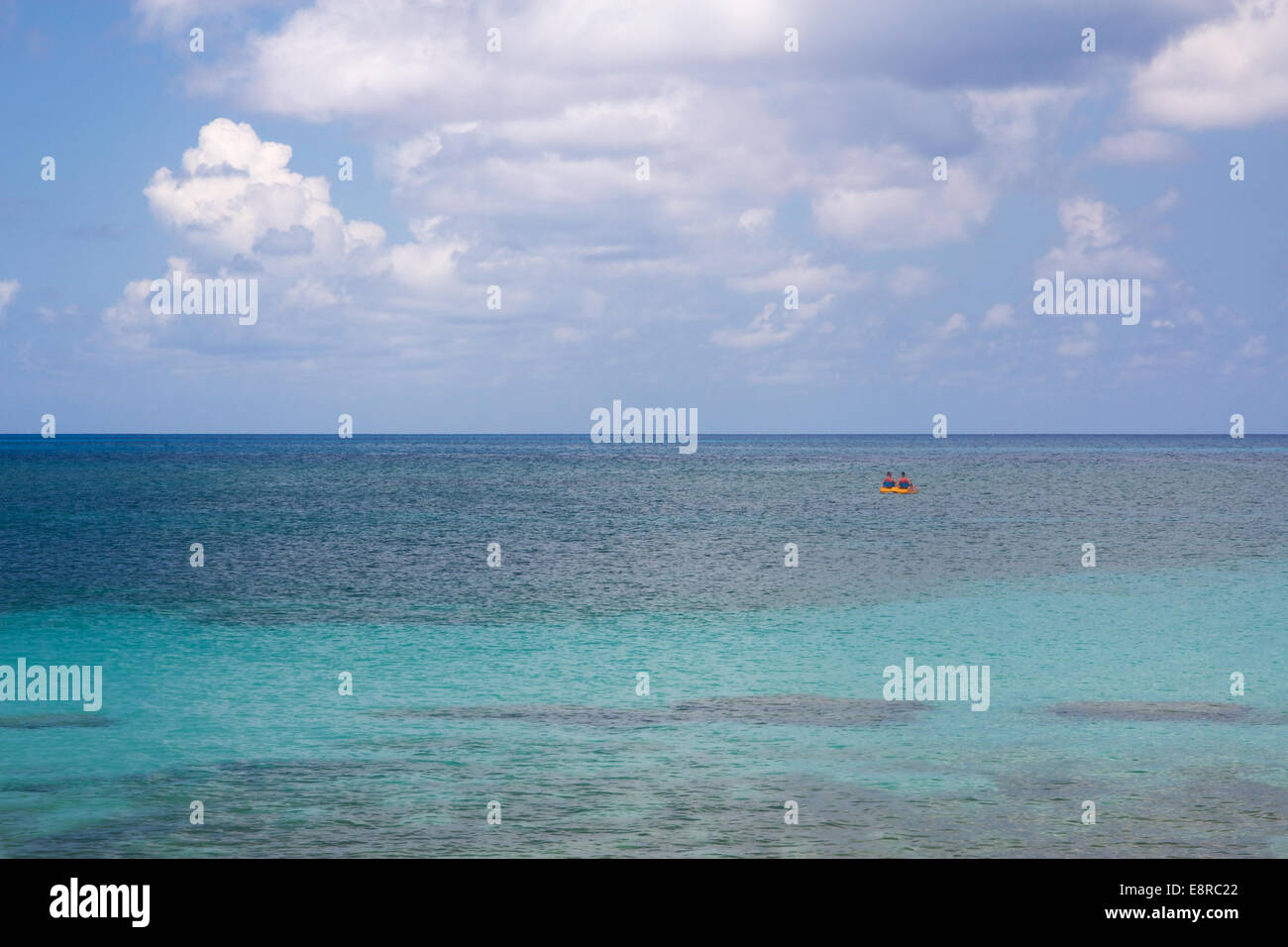 Tiny paddle boat in the vast Caribbean ocean Stock Photo - Alamy