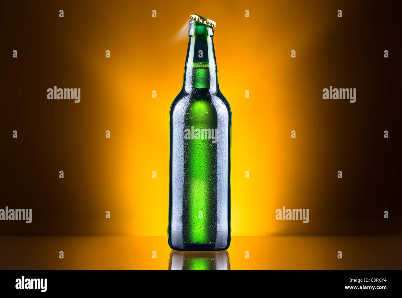 open wet beer bottle on a colored background Stock Photo - Alamy