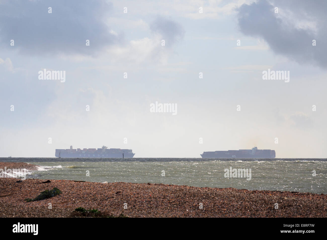 Two fully laden container ships passing on way into port from beach ...