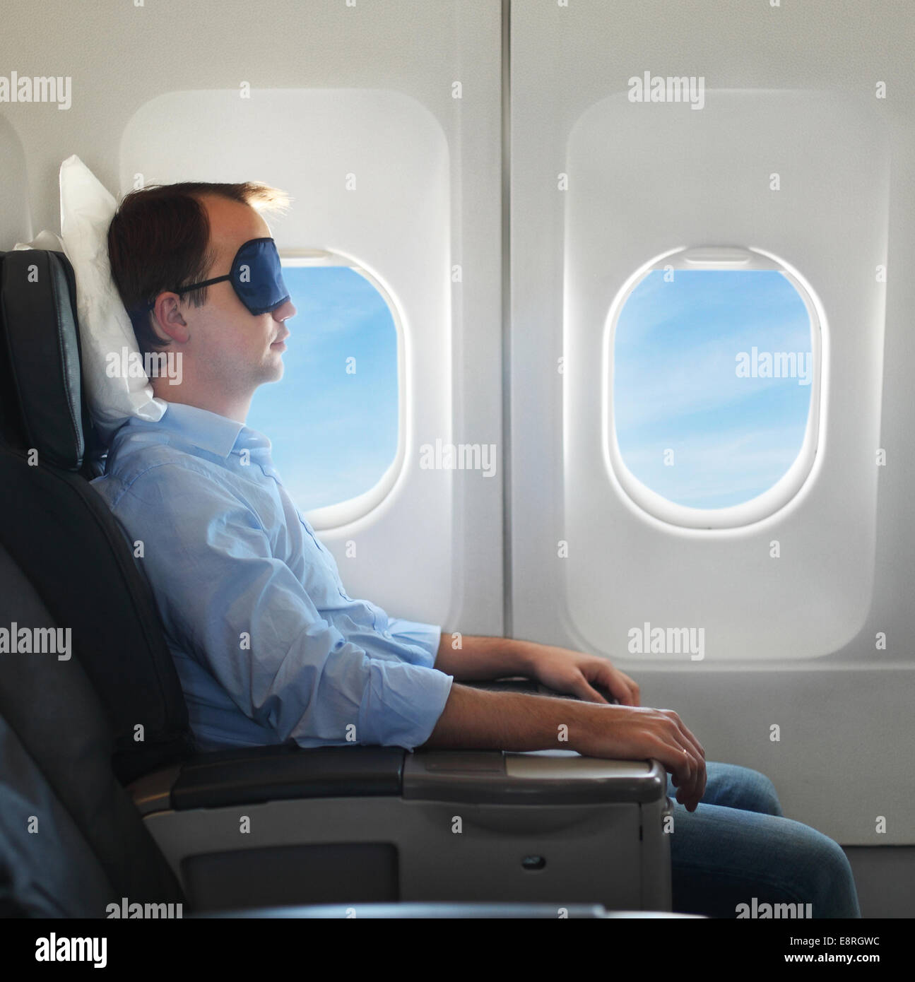 Portrait of man relaxing in sleaping mask in the airplane Stock Photo ...