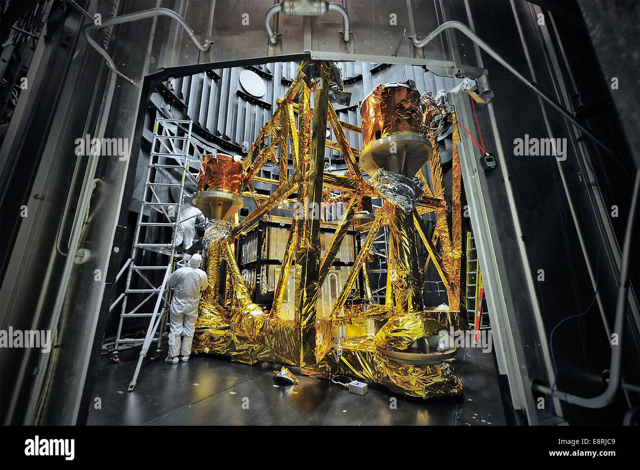 This photograph shows NASA support structures wrapped in gold thermal ...