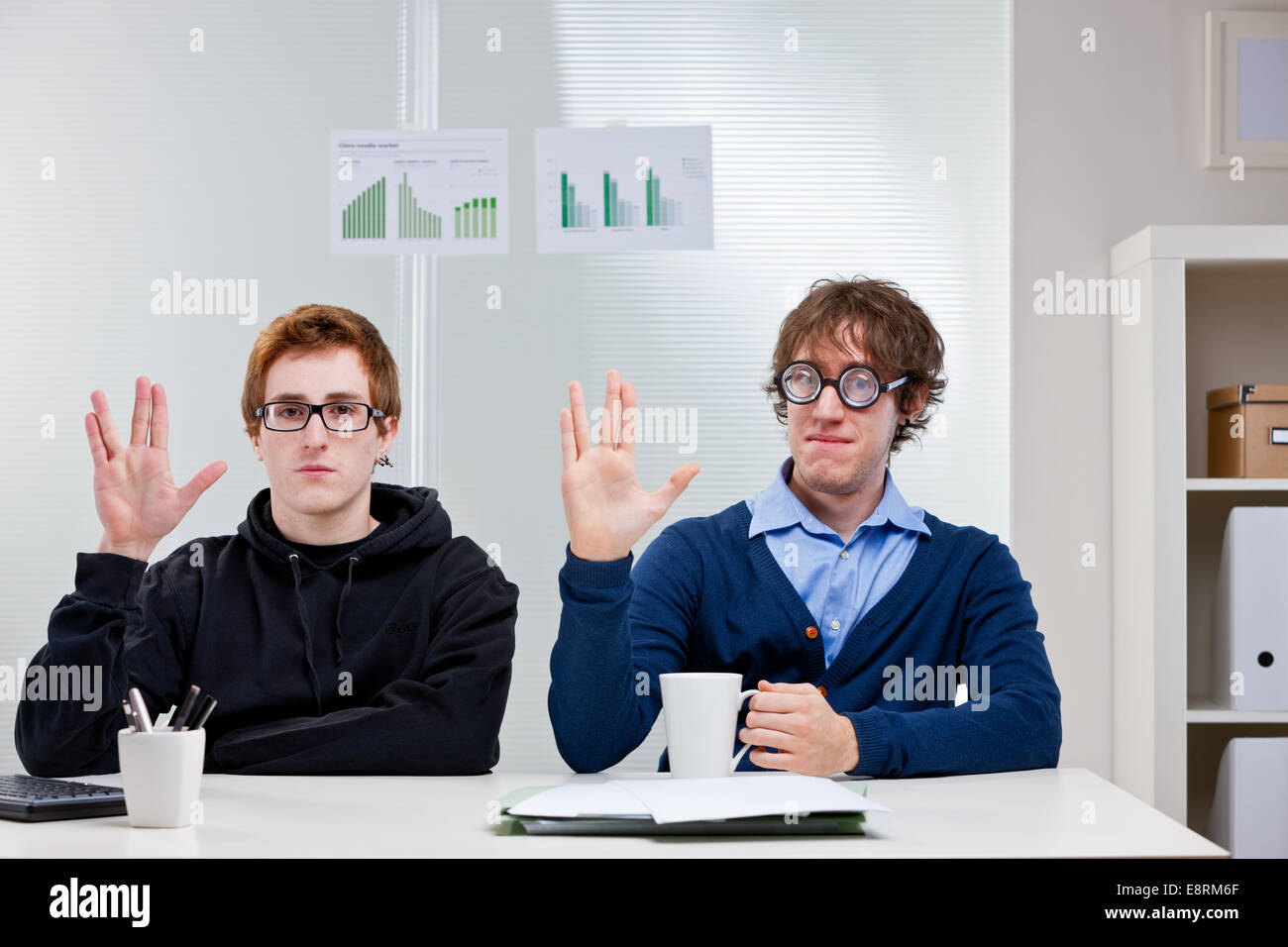 a couple of nerd office workers showing a very popular science fiction ...