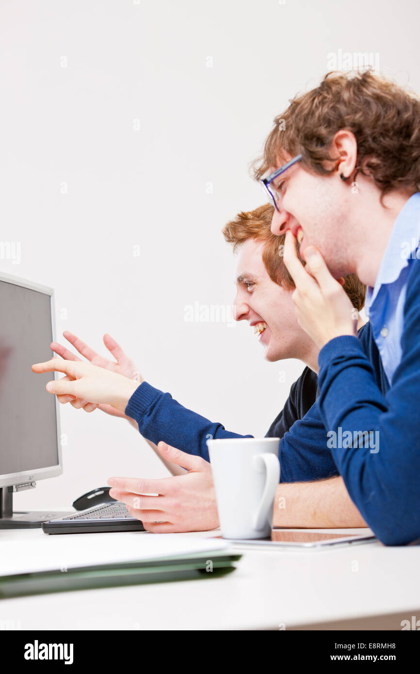 copyspace ready screen and two workers smiling at it Stock Photo - Alamy