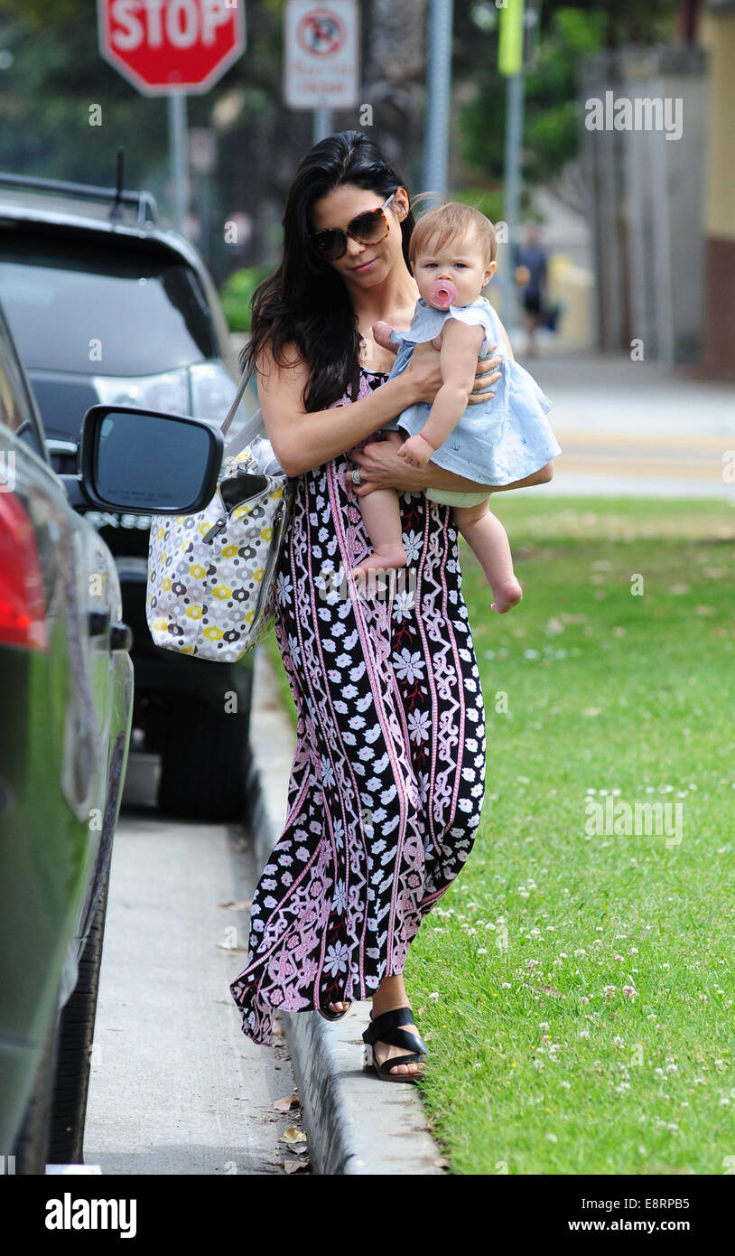 Jenna Dewan-Tatum in a summer floral maxi dress, carries her daughter ...