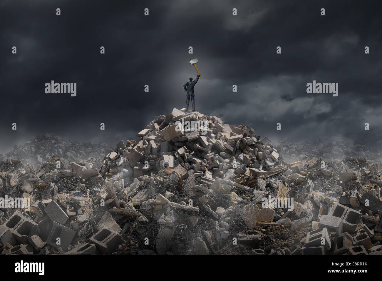 Destroy and demolish concept as a businessman standing on a mountain of ...