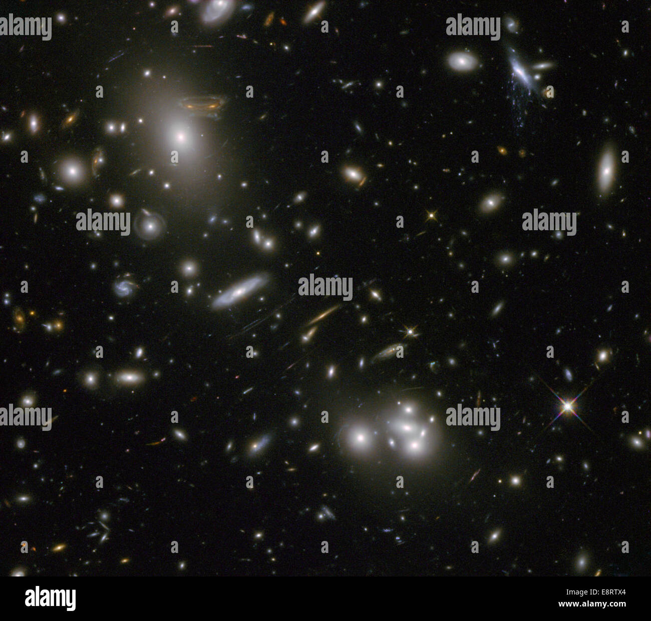 The gravitational field surrounding this massive cluster of galaxies ...