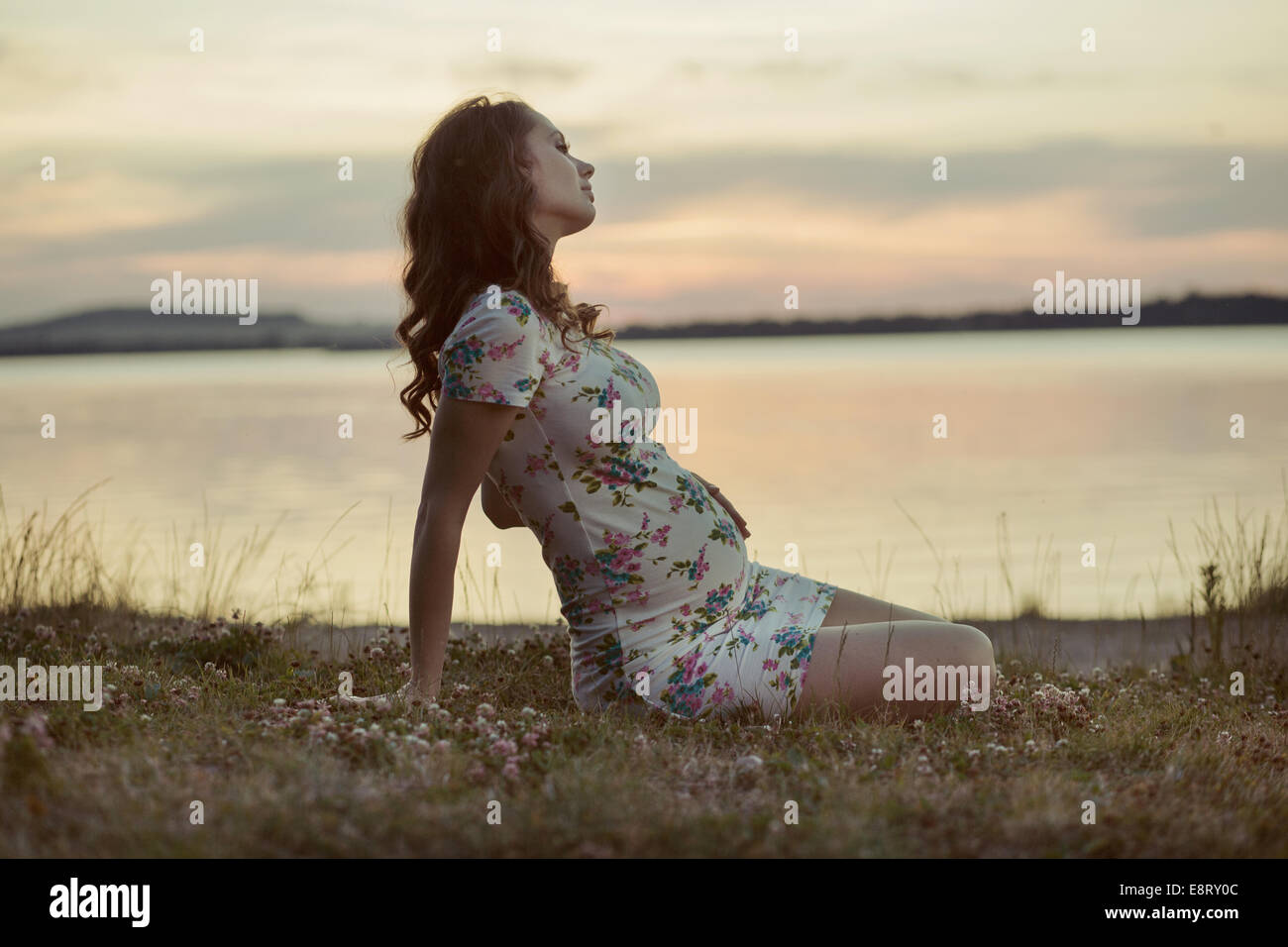 Adorable pregnant mother resting by the lake Stock Photo - Alamy