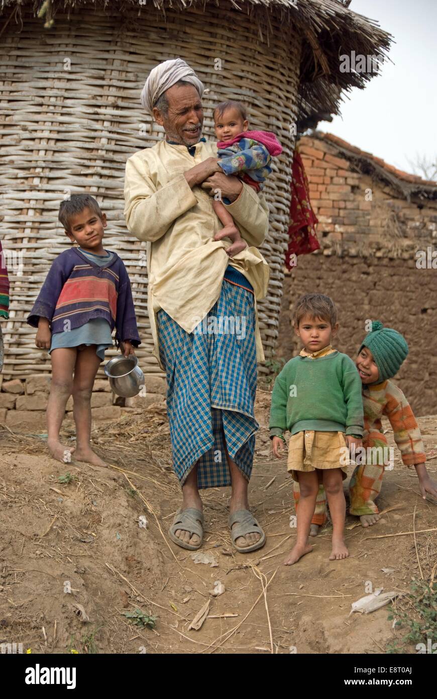 Elderly gentleman holds the young child. Rural village people young and ...