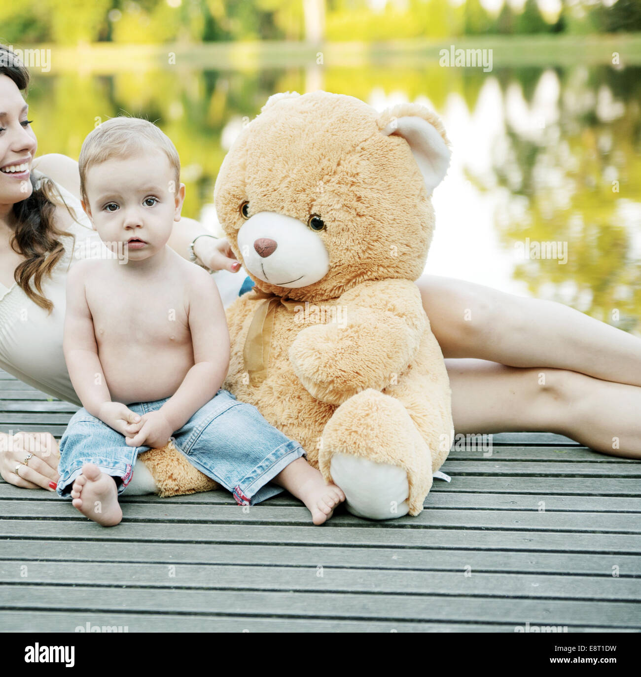Mother looking after her playing son Stock Photo - Alamy
