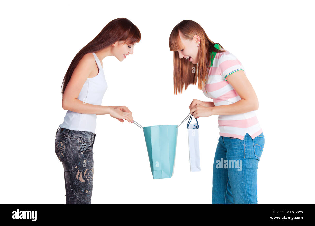 two girls look in a paper package bag Stock Photo - Alamy