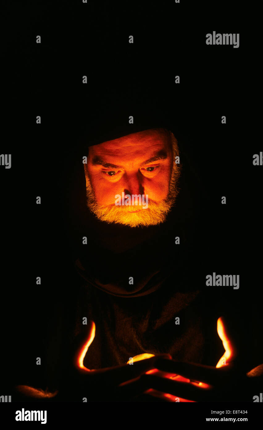 CHARACTER MAN WIZARD OR FORTUNE TELLER LOOKING DOWN INTO EERIE LIGHT ...