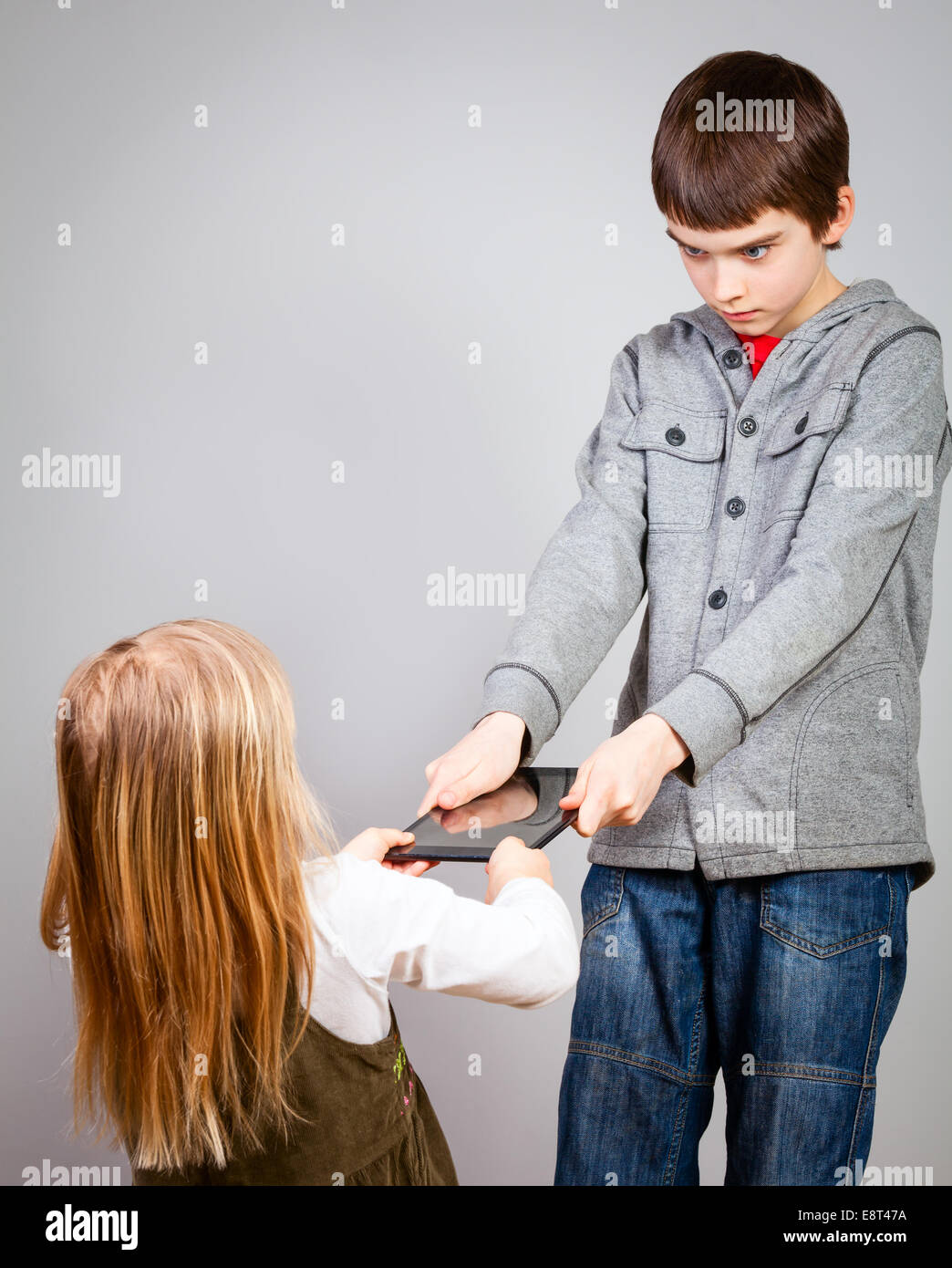 Children fight for tablet computer Stock Photo - Alamy